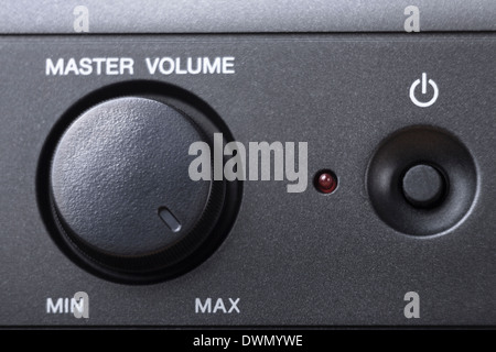 Volume control knob of a black amplifier with dial numbers. Close up ...