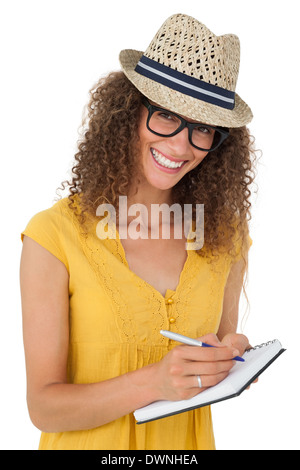Brunette woman in glasses with notepad in hands stands in the office ...