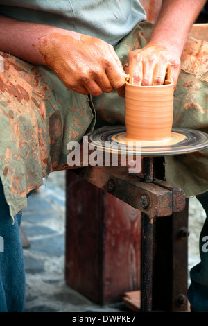 Potter is creating earthenware on potter's wheel Stock Photo - Alamy
