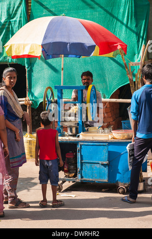 sugar cane juice or "ganne ka ras" with cut pieces cane on white ...