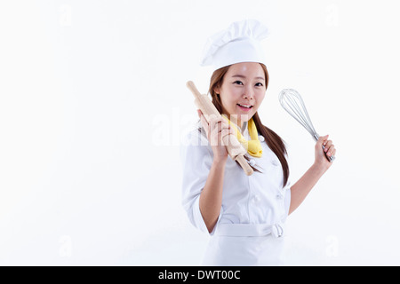 a female posing with utensils in professional cook outfit Stock Photo ...