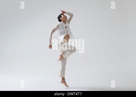 a man wearing white making dance poses Stock Photo - Alamy