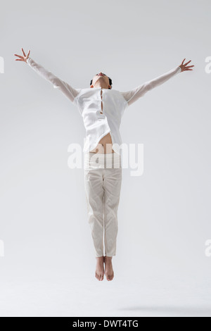 a man wearing white making dance poses Stock Photo - Alamy