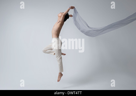 a man wearing white making dance poses Stock Photo - Alamy