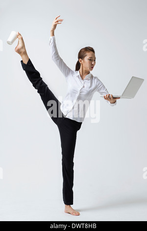 a woman making dance poses with a laptop Stock Photo - Alamy