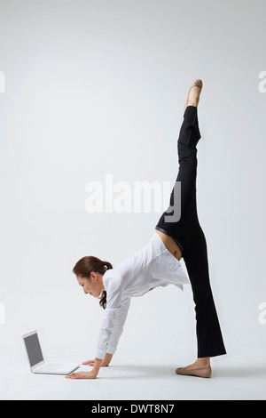 a woman making dance poses with a laptop Stock Photo - Alamy
