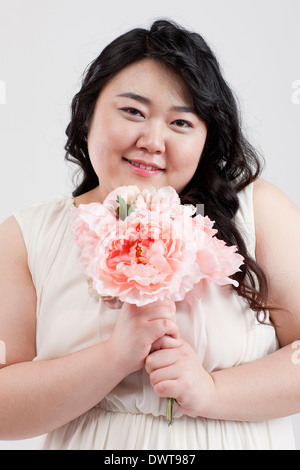 a fat woman posing with flowers Stock Photo - Alamy