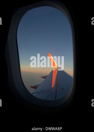 View of wing of Jetstar airplane at sunset from passenger seat after ...