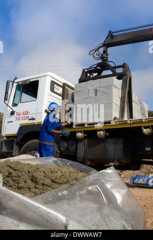 Alec Windvogel is a crane operator offloading bricks at a low cost ...