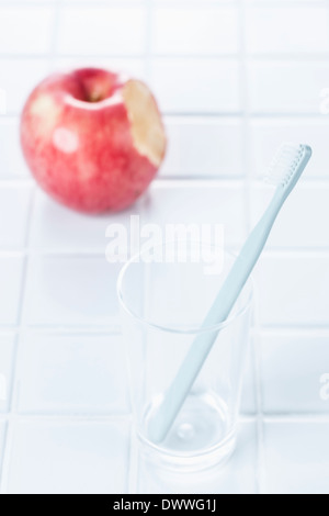 a toothbrush next to an apple Stock Photo - Alamy