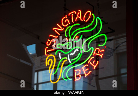 Neon sign of Chinese TSINGTAO beer on a Chinatown restaurant window.New ...