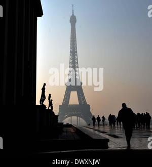 People walk near the Eiffel Tower during a snowfall Wednesday, Jan. 7 ...