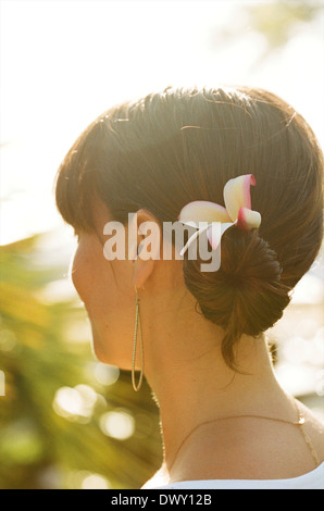 Stylish young woman with brown hair checks her tablet beside a modern ...