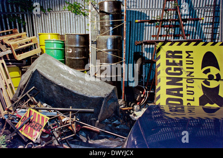 A " Danger Plutonium" warning sign and old oil drums in a backyard ...
