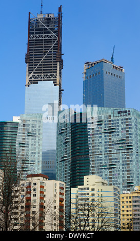 Modern high-rise building under construction with glass windows and ...