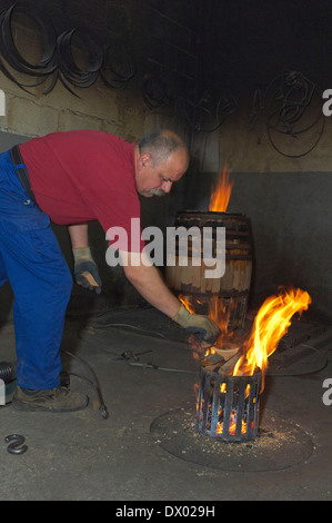 Burning, toasting the barrel with fire. Cooperage, barrel Stock Photo ...