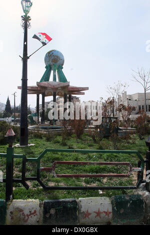 Syrian Flag and photo of Bashar al-Assad on the front gate of the ...