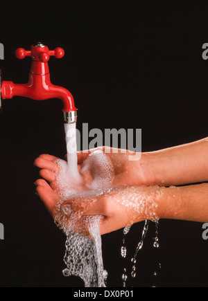 Washing hands under flowing tap water flow on sink Stock Photo - Alamy