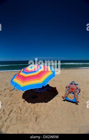 beach umbrella rainbow Stock Photo - Alamy