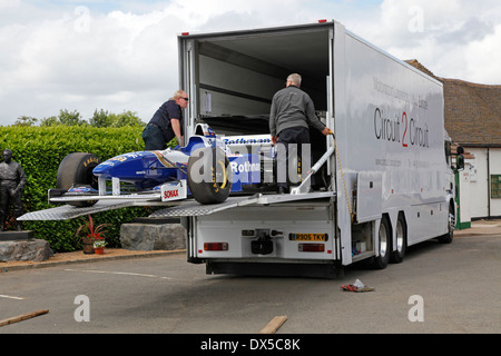 Loading a Williams F1 car designed by Adrian Newey into a car ...
