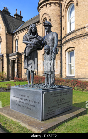 A statue of a miner and his family in front of the NUM building ...