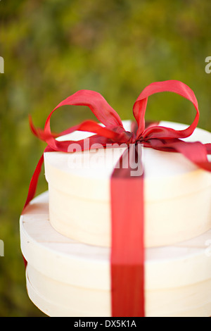White Gift Box with Red Ribbon and Bow Near Man Typing on Laptop ...