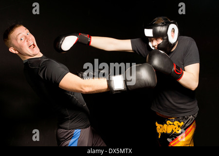 Young male boxer being punched in the jaw with red boxing glove Stock ...