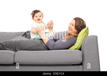 Adorable toddler lying on sofa bitting fingers at home Stock Photo - Alamy