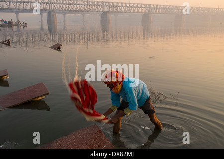 Dhobi wallah washing laundry in the river with neatly arranged washing ...