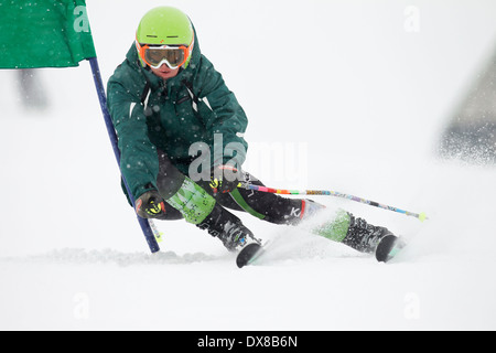 An alpine skier rounding a gate while racing on the giant slalom course ...