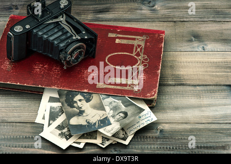 Album with vintage photos on wooden background Stock Photo - Alamy