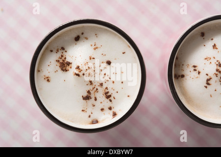 Cappuccino in pink cup with cocoa and almond milk foam Stock Photo - Alamy