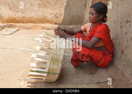 Tribal woman making baskets with dry bamboo strips. Birhor tribe ...