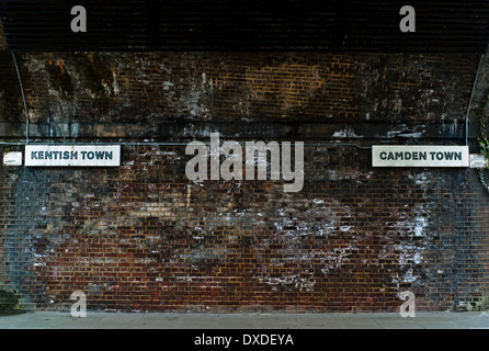 Kentish Town and Camden direction signs on railway bridge, dividing ...