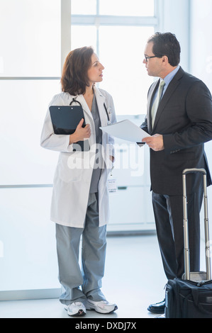 Female doctor and pharmaceutical sales representative shaking hands ...