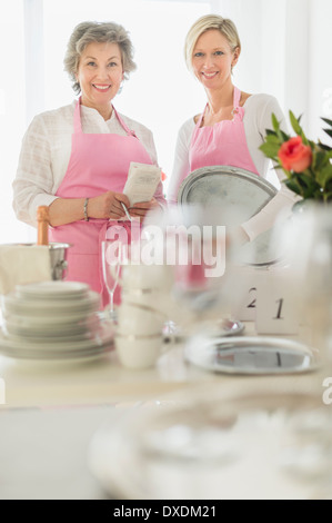 Two mature women preparing catering Stock Photo - Alamy