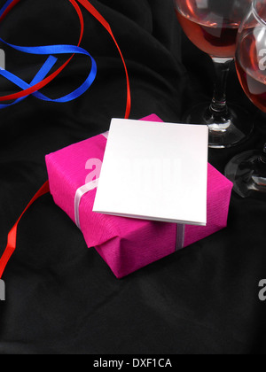 Valentine day gift box and wine glasses, with gold heart decor over red ...