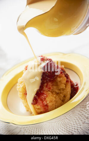 Bowl Of Steamed Jam Pudding With Jug Of Custard Stock Photo - Alamy