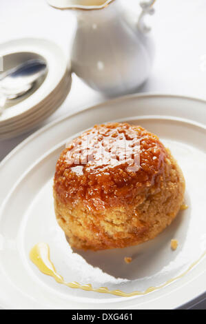 Bowl Of Steamed Syrup Pudding With Jug Of Custard Stock Photo - Alamy