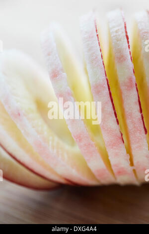 Peeled And Sliced Red Devil Apple On Wood Stock Photo - Alamy