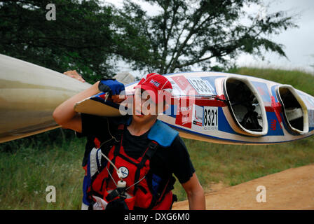 Paddlers portaging past Inanda Dam wall on the Dusi Canoe Marathon ...