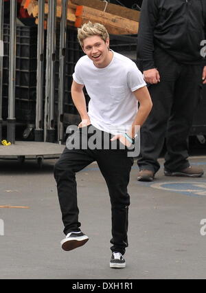 One Direction band members playing soccer in the parking lot of the X ...