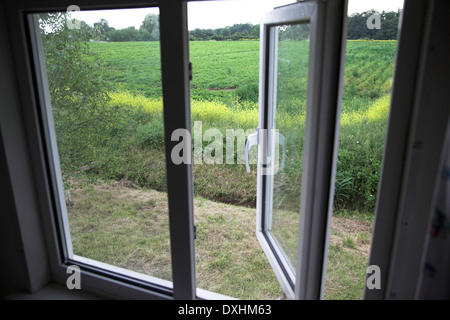 Open window with fresh air and countryside scenery views. Red curtains ...