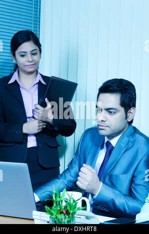 Two employees discussing the electronic document in a laptop Stock ...