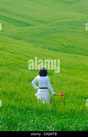 Rear view of woman standing on cliff against Crater Lake Stock Photo ...