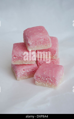 A pile of pink and white coconut ice, a traditional sweet made from ...