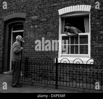 Neighbors talking over the fence Stock Photo - Alamy