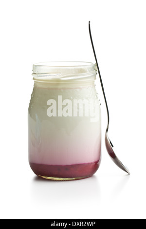 Fresh yogurt in glass jar with berry fruits on dark background. Healthy ...