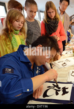 Japanese artist and calligraphy master HARU (L) instructs school ...