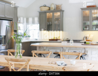 Table of food in foreground with people eating in background Stock ...